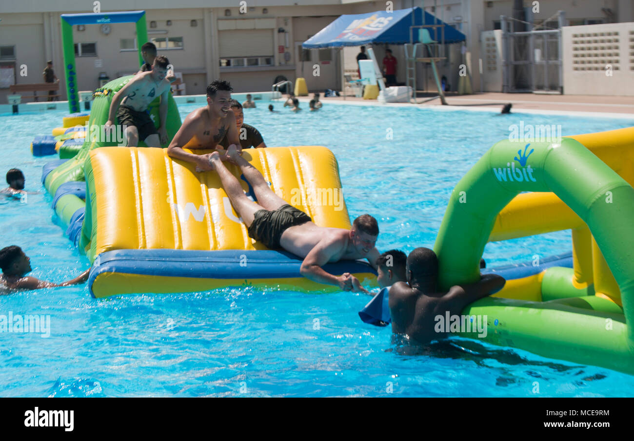 Marines with 3rd Marine Logistics Group compete in an aquatic obstacle ...