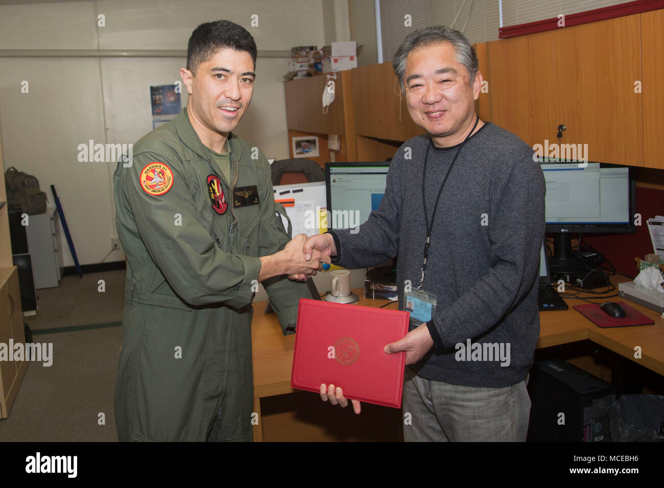 U.S. Marine Corps Capt. Justin Ito, left, the officer in charge of the ...