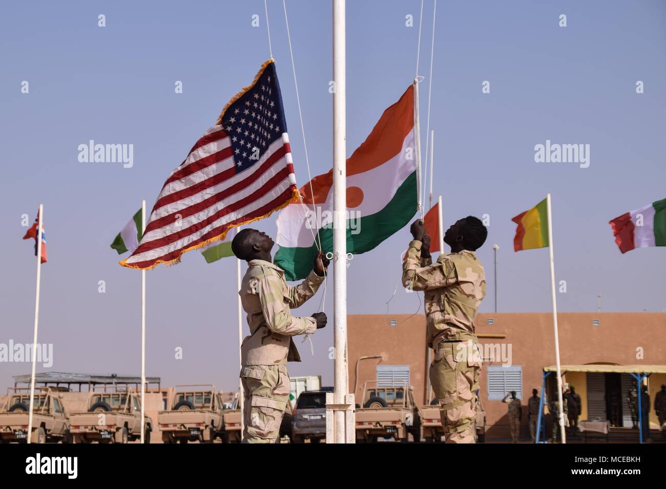Soldiers assigned to the Forces Armees Nigeriennes raise the Nigerien ...