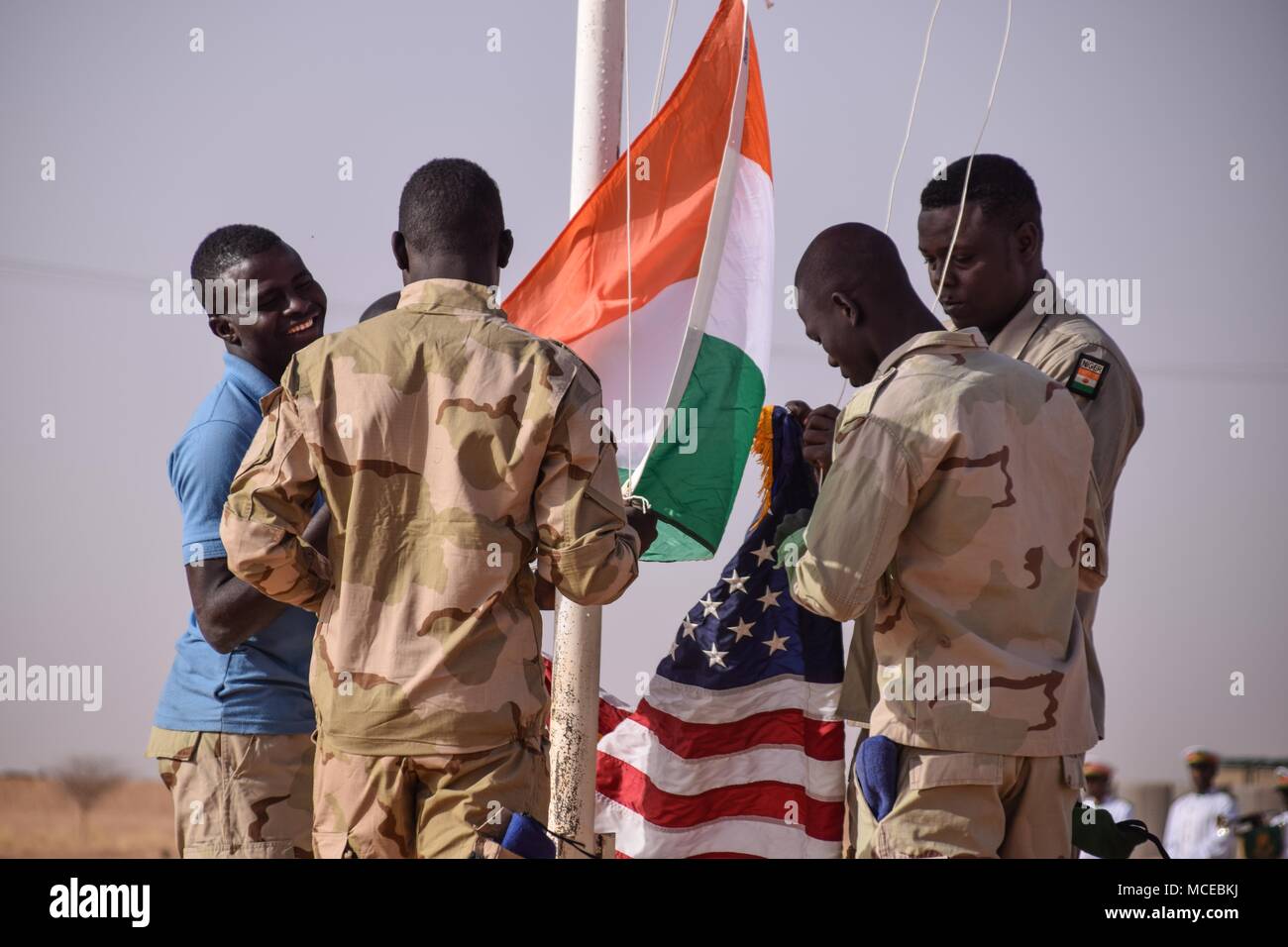 Soldiers assigned to the Forces Armees Nigeriennes prepare to raise the ...
