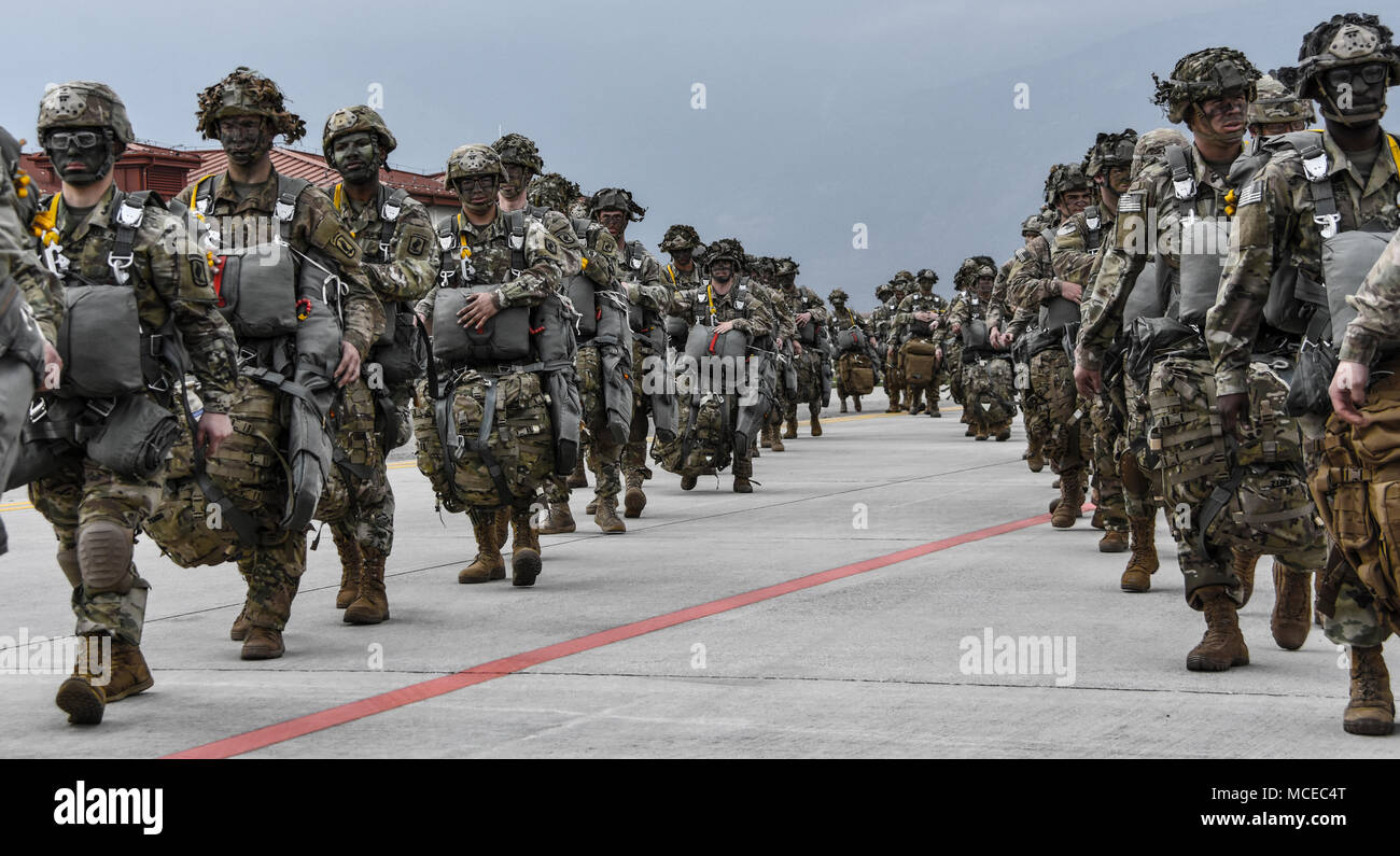 Bearing the weight of heavy combat loads, paratroopers from the 173rd ...