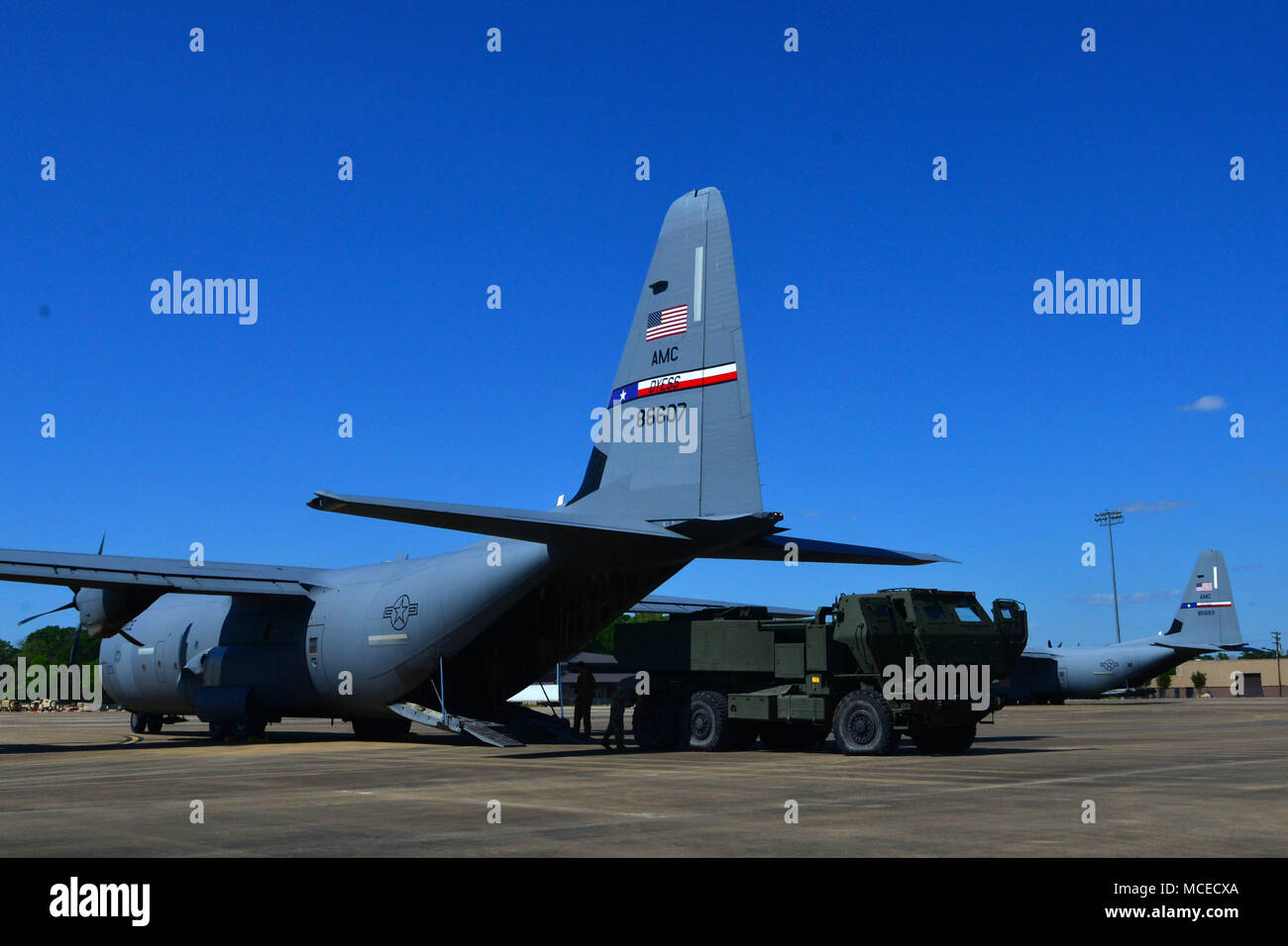 An M142 High Mobility Artillery Rocket System is loaded onto a C130-J ...