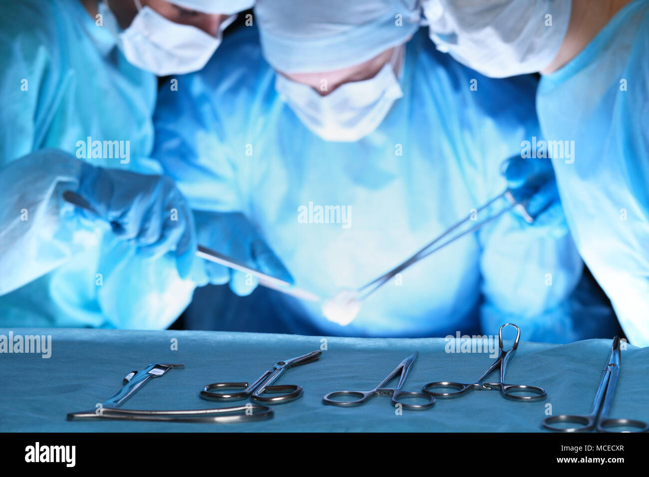 Closeup of surgeons performing operation. Focus on professional tools ...