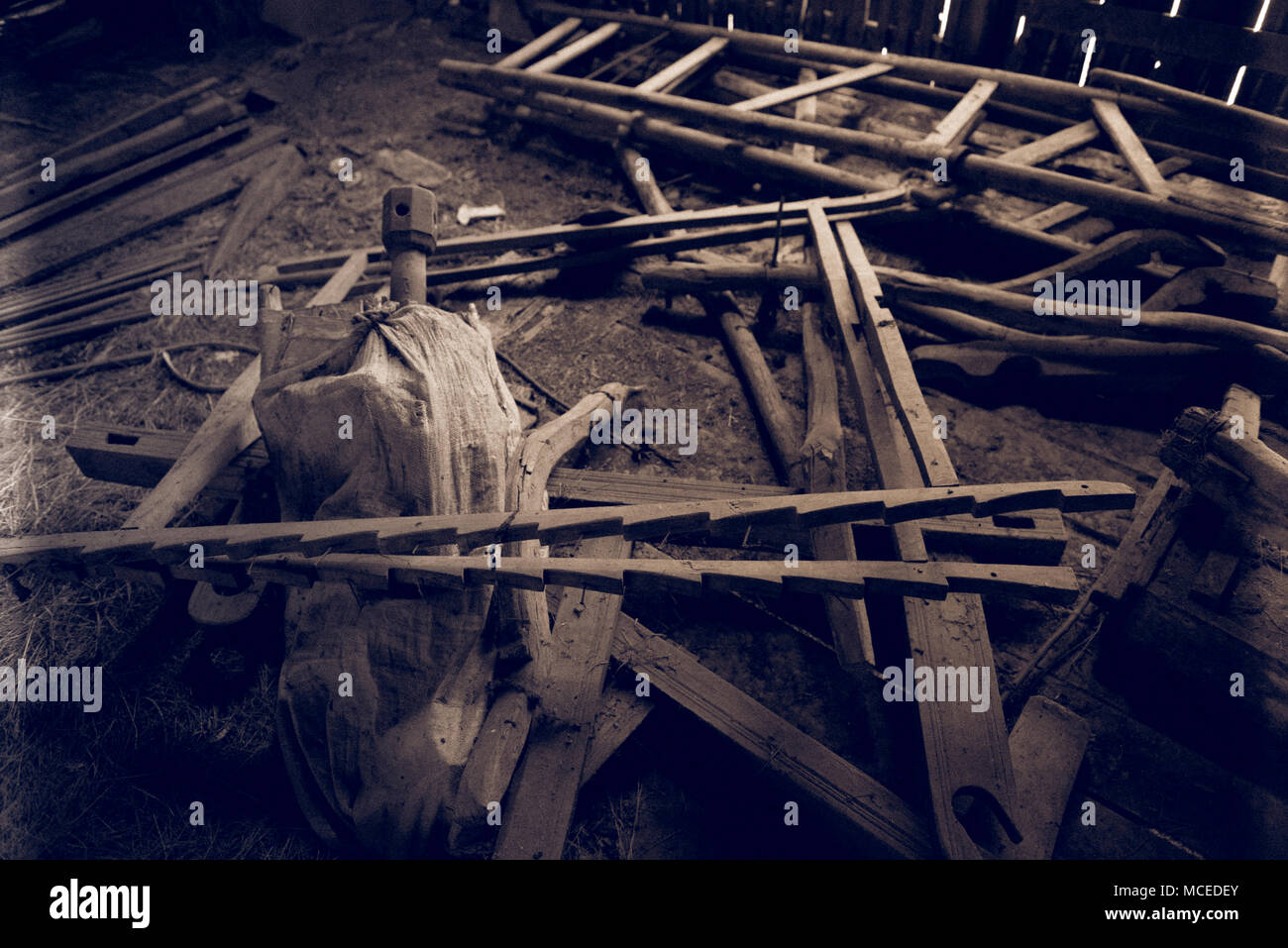 Vintage wooden objects in abandoned barn. Traditional tools in a shed ...