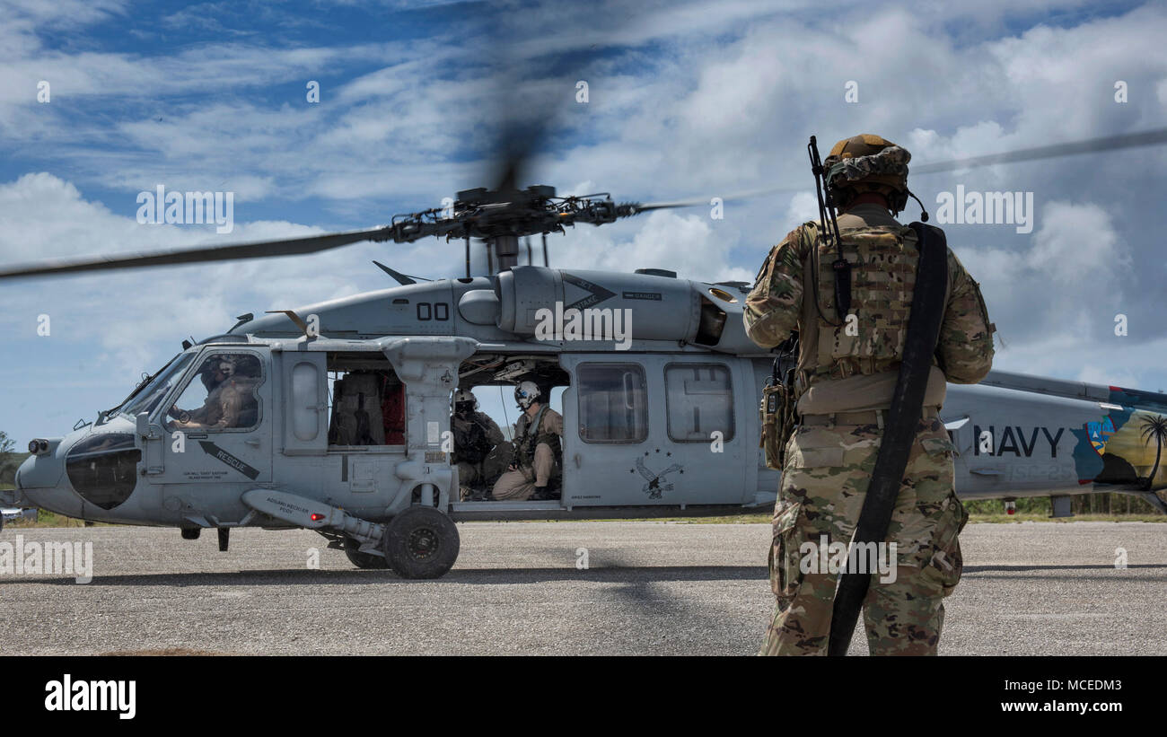 An Airman assigned to the 36th Mobility Response Squadron waits for a ...