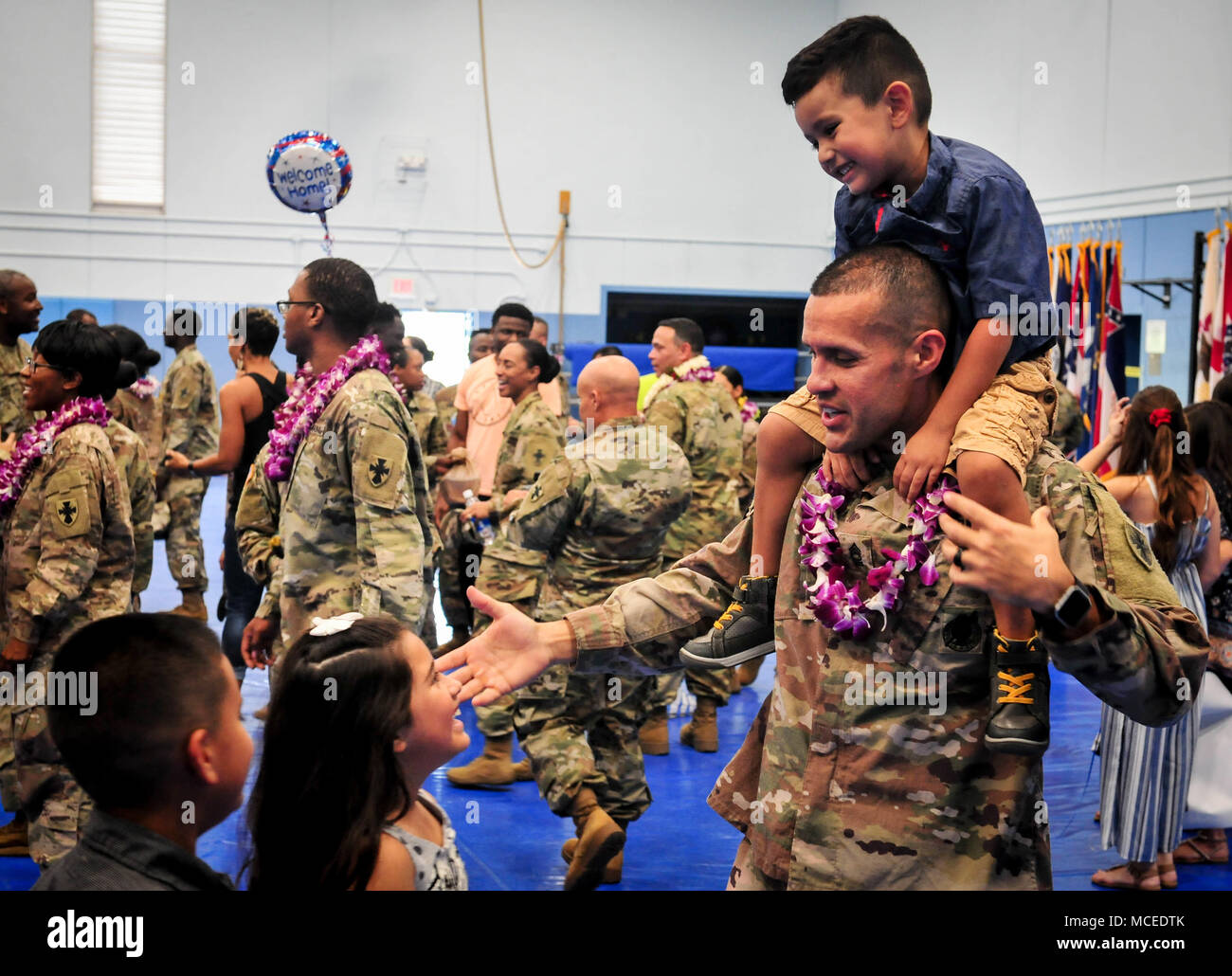 A Soldier with the 8th Human Resources Support Center greets his family ...