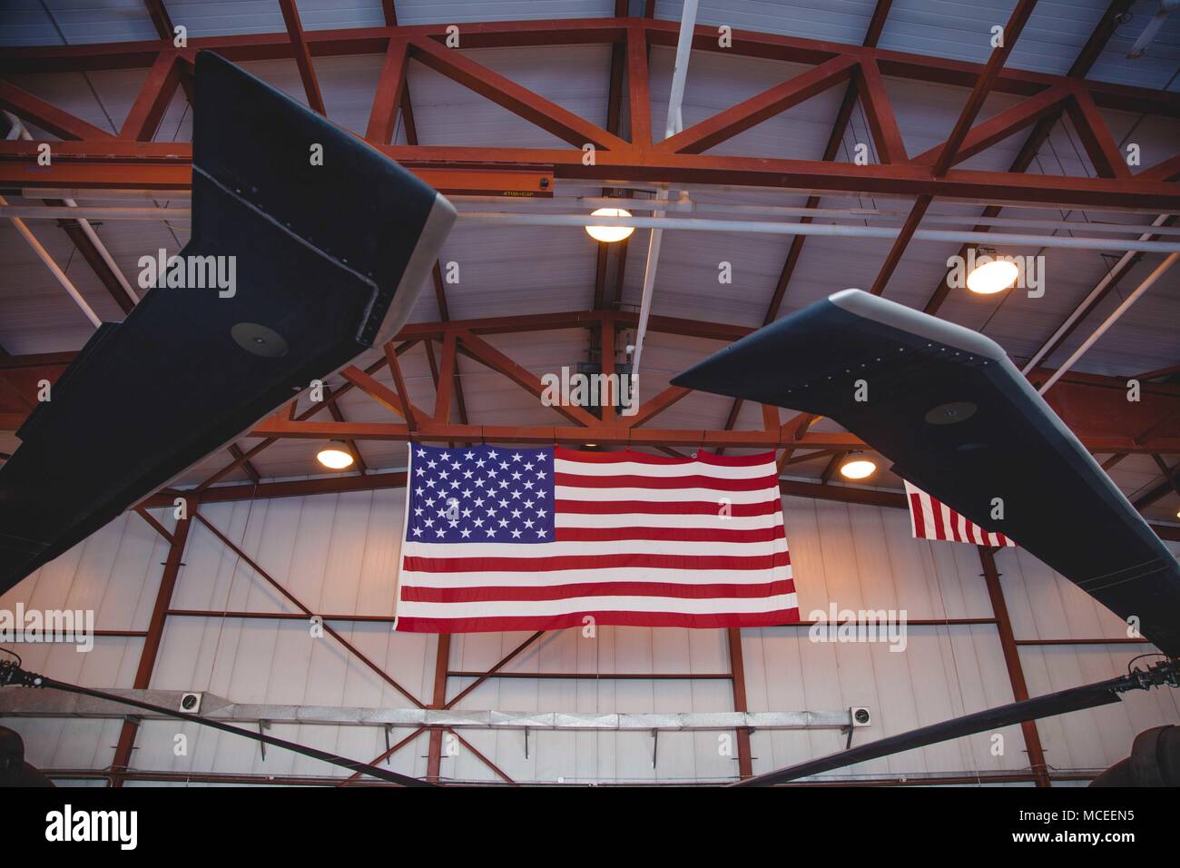 The United States flag hangs freely from the hangar rafters at the ...
