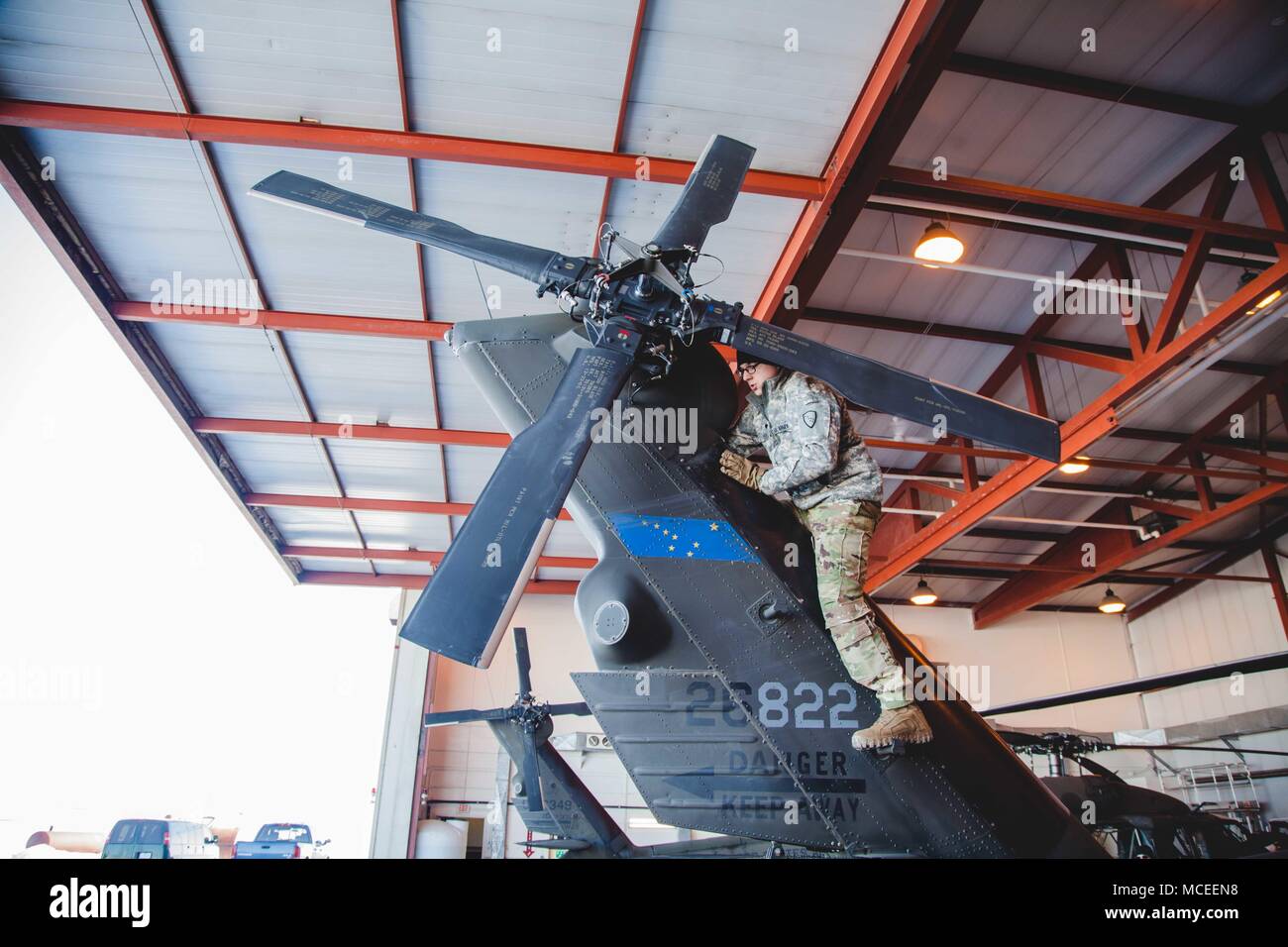A UH-60 Black Hawk maintenance technician checks the tail rotor during ...