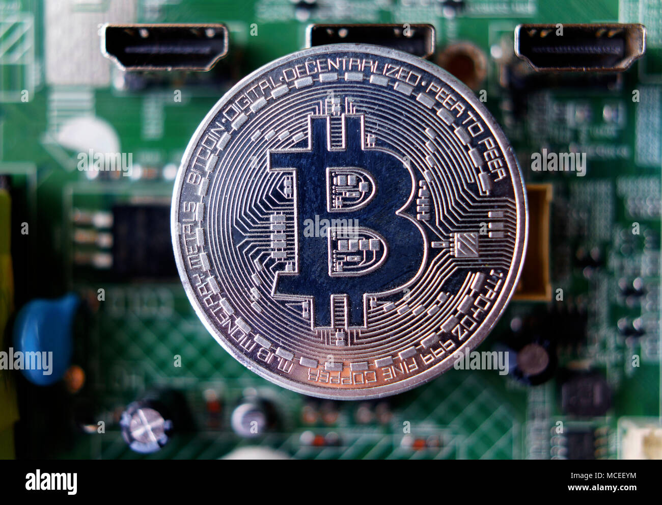 Silver souvenir coin Bitcoin on computer circuit board background Stock ...