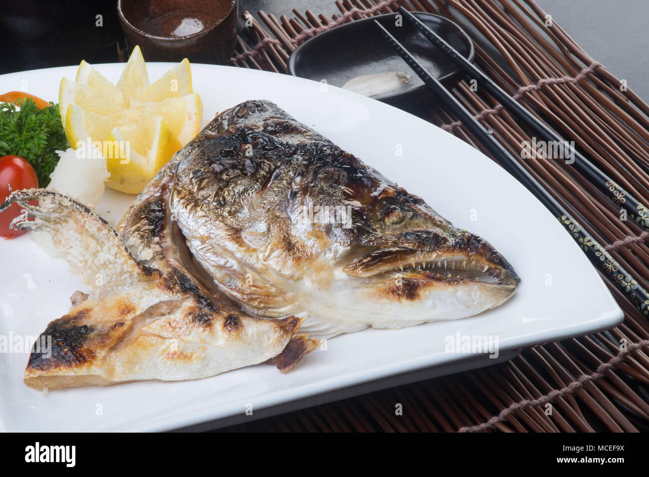 japanese cuisine. fried fish head on background Stock Photo - Alamy