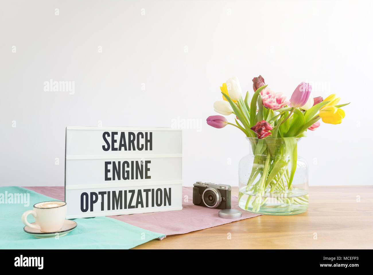 Search engine optimization written on light box for websites on wooden ...
