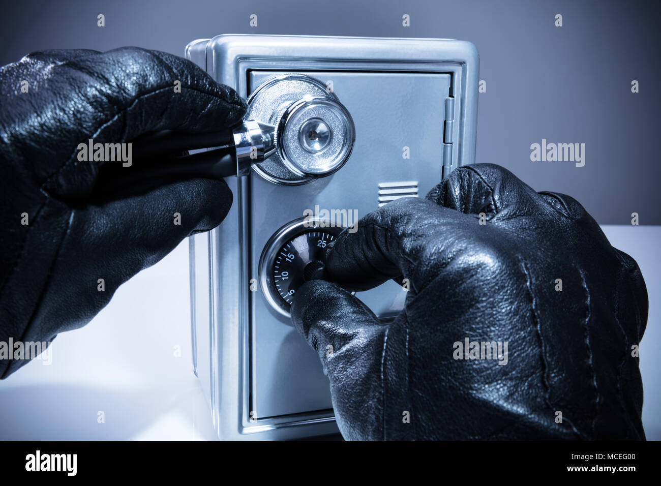 Close-up Of A Thief's Hand Using Stethoscope While Unlocking Safe Stock ...