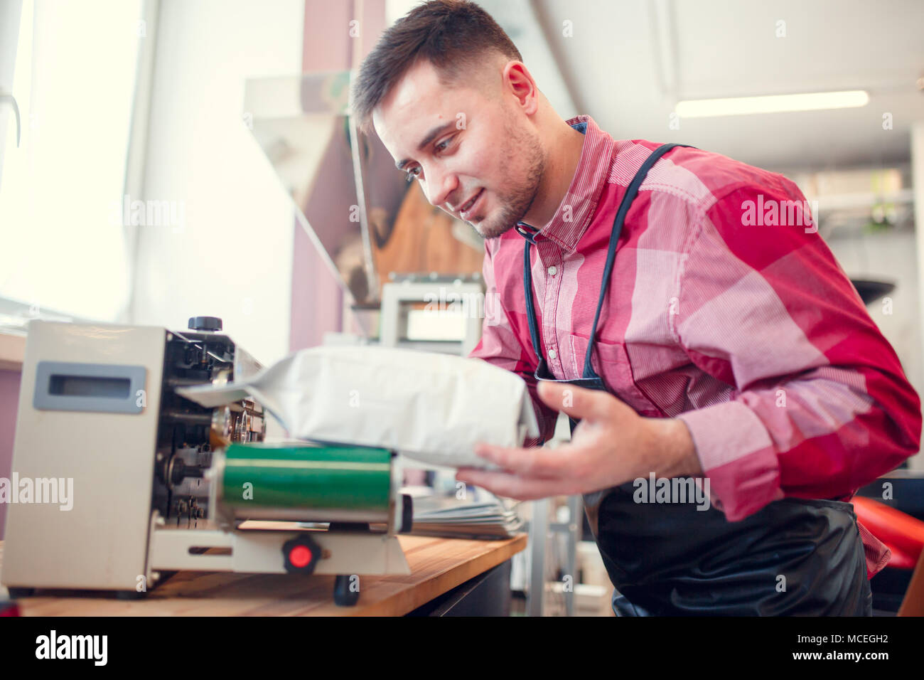 Portrait of man with paper bag next to apparatus Stock Photo - Alamy