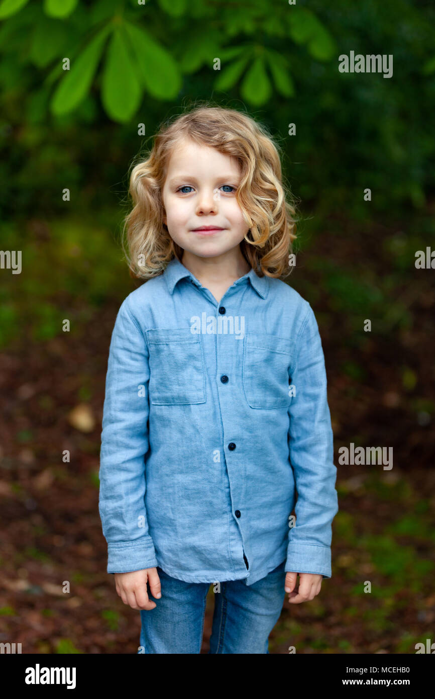 Little Boy With Blonde Hair And Green Eyes