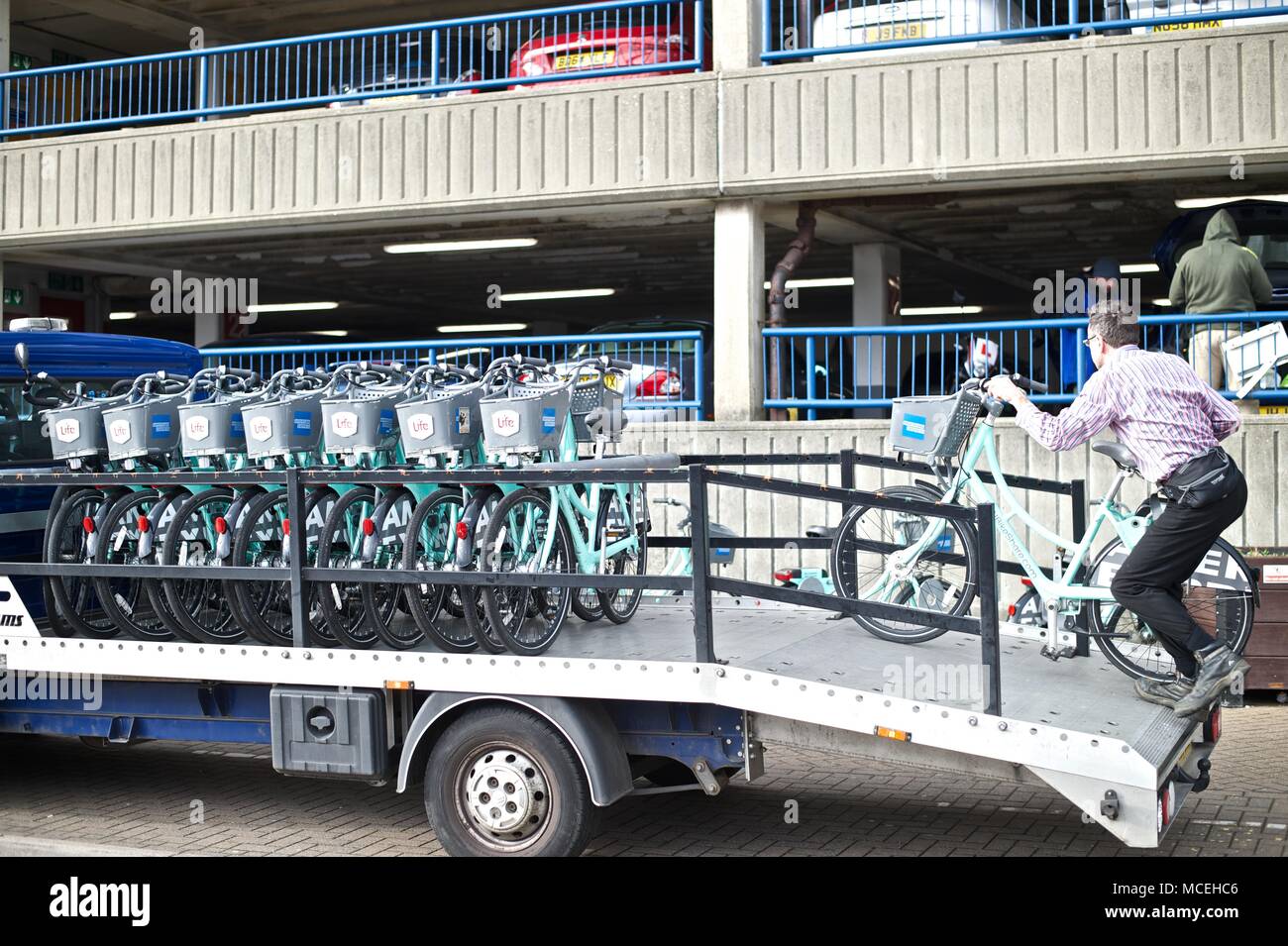 Brighton Bike Hire scheme with man offloading bikes at docking station ...