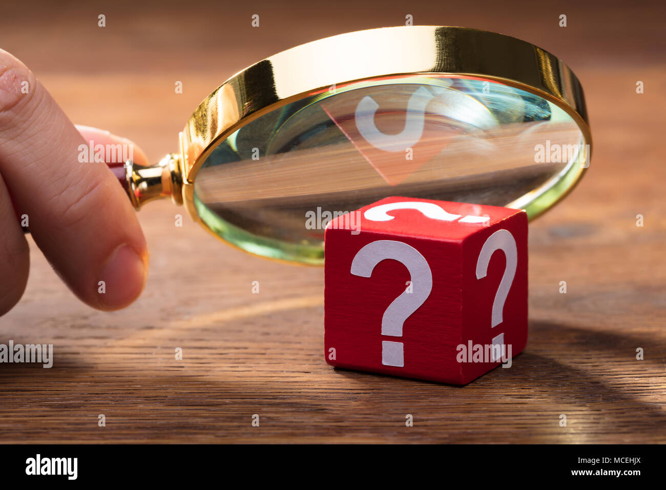 Close-up Of A Person Looking At Wooden Question Mark Red Block Through ...