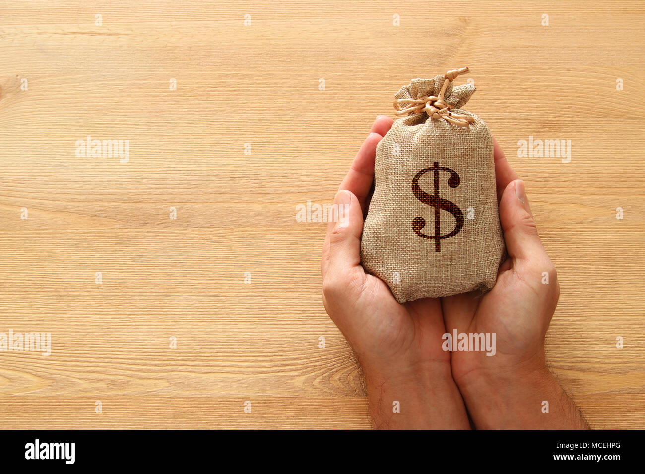 Hand holding bag money over hi-res stock photography and images - Alamy