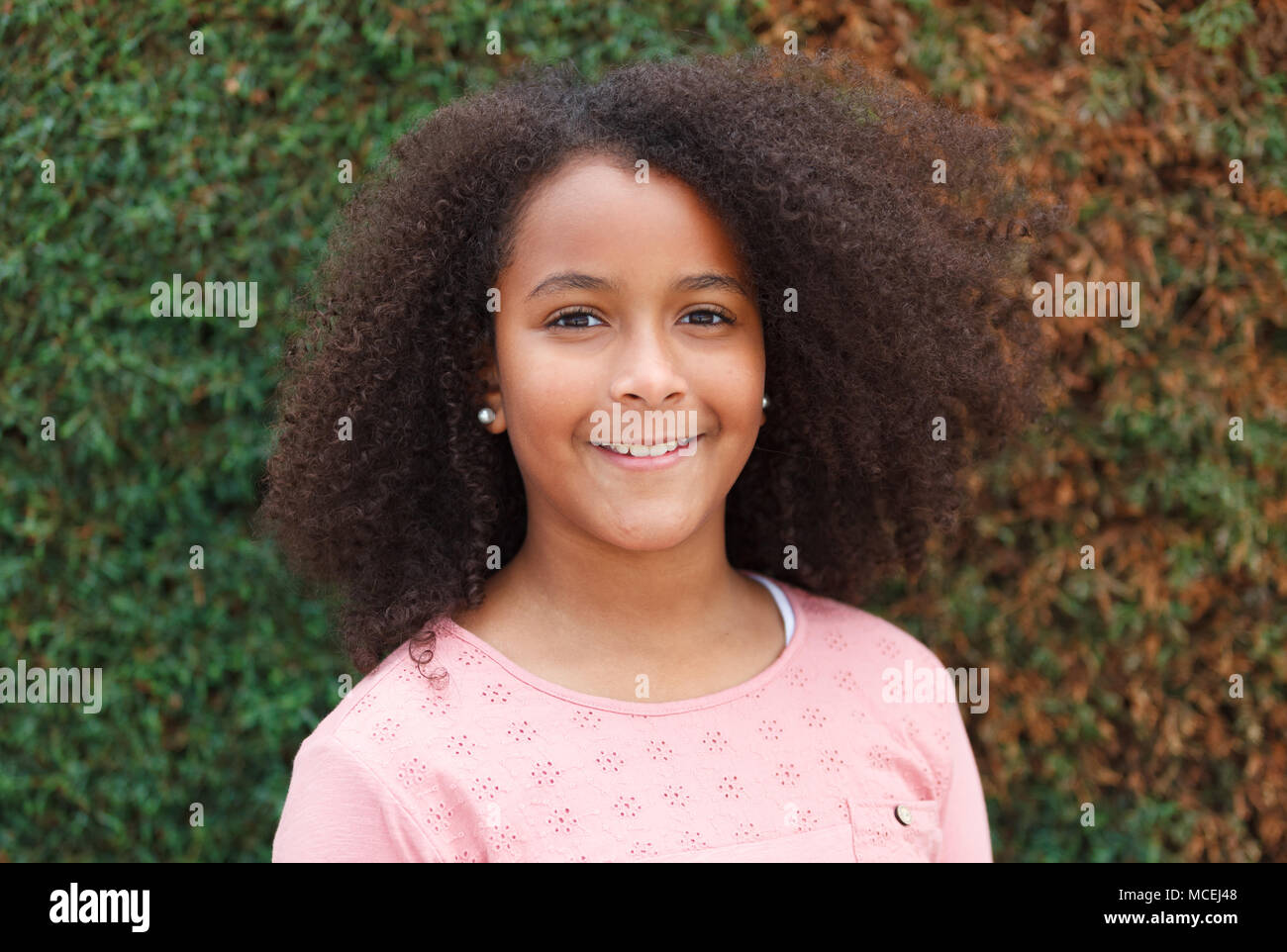 Beautiful child with afro hair in a park Stock Photo - Alamy