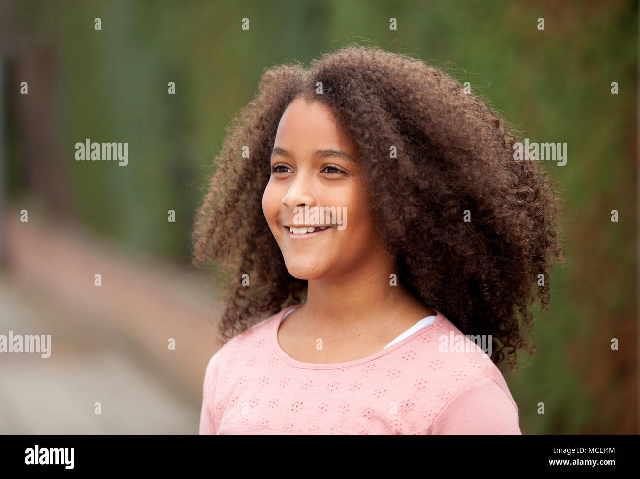 Beautiful child with afro hair in a park Stock Photo - Alamy