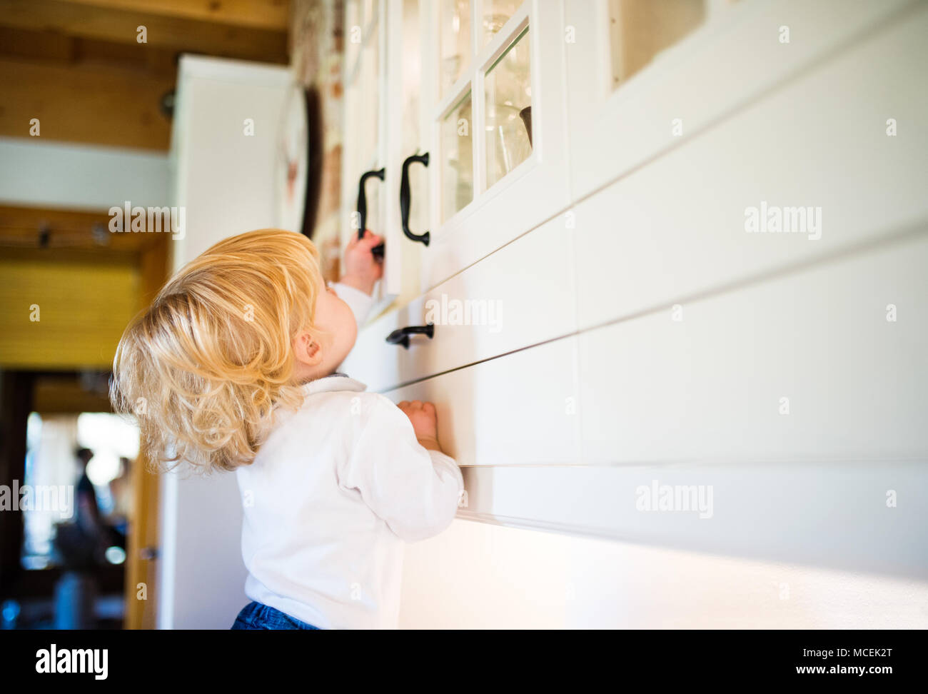 Toddler boy in dangerous situation at home. Child safety concept Stock ...
