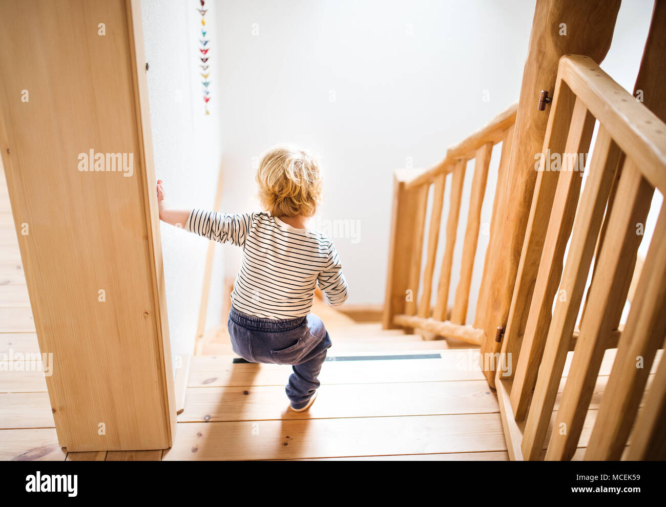 Toddler boy in dangerous situation at home. Child safety concept Stock ...