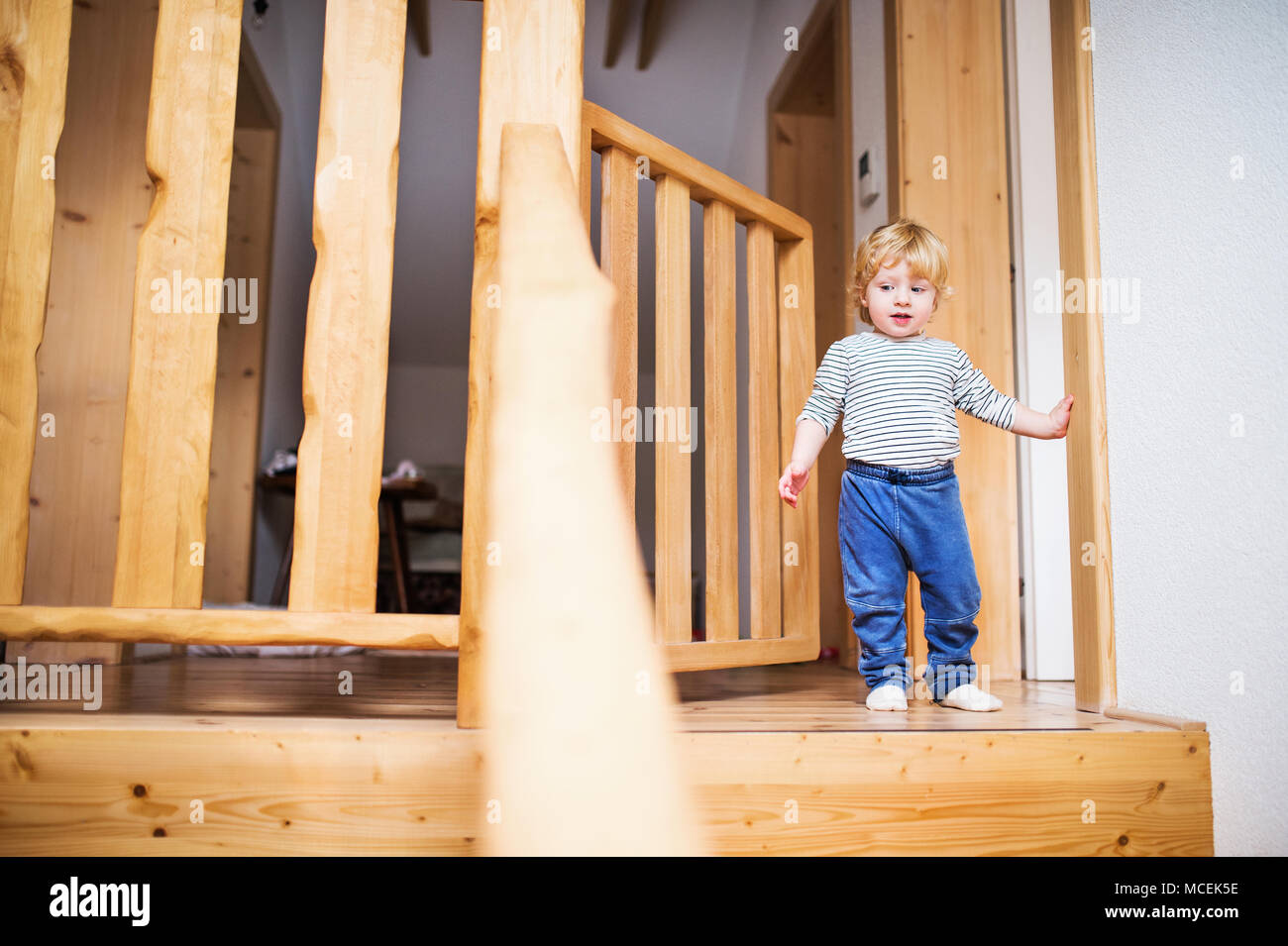Toddler boy in dangerous situation at home. Child safety concept Stock ...