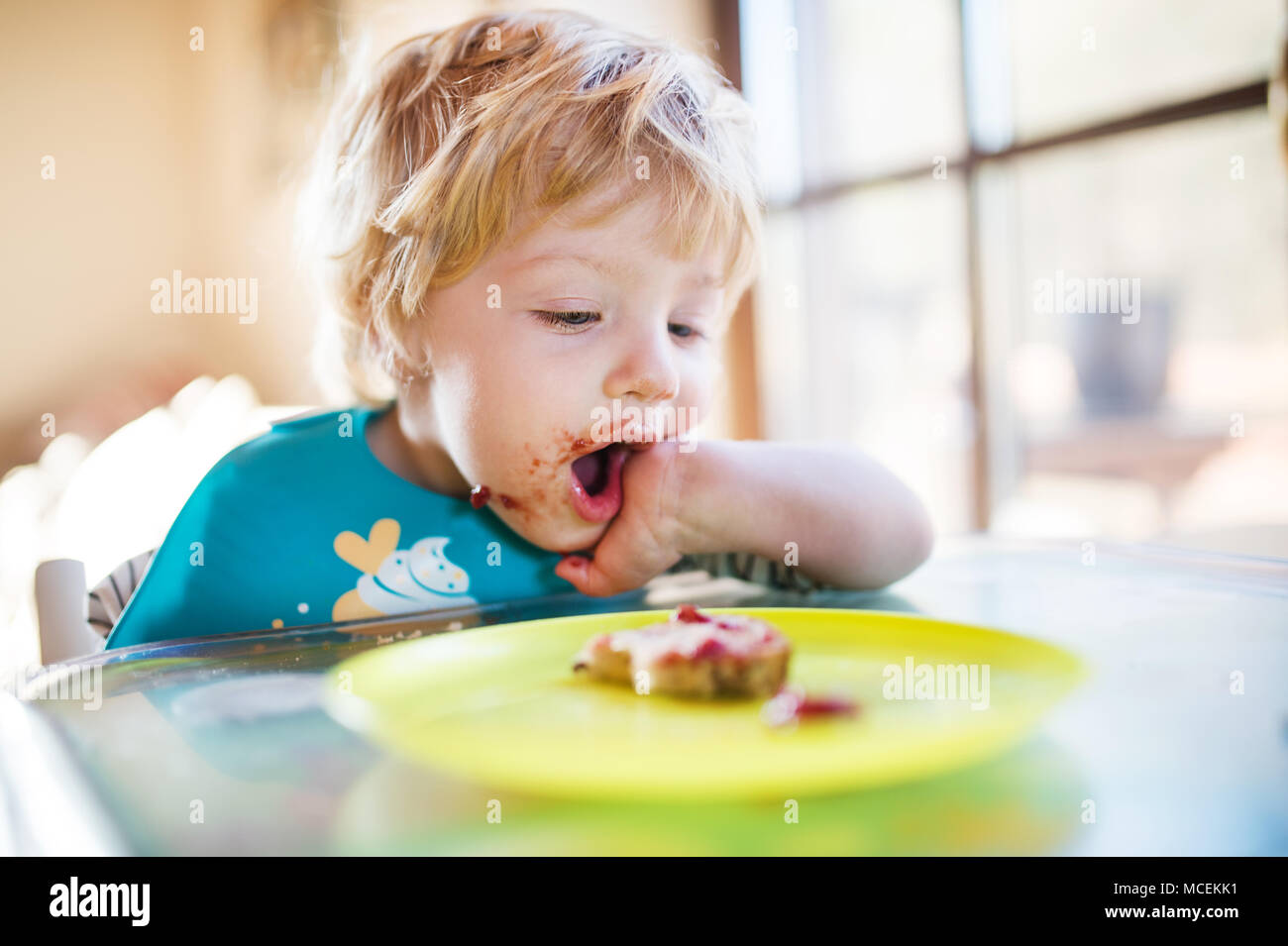 A toddler boy eating at home Stock Photo - Alamy