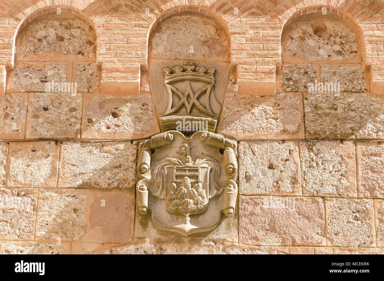 A coat of arms on a stone wall at Santa Maria de Montserrat Abbey in ...