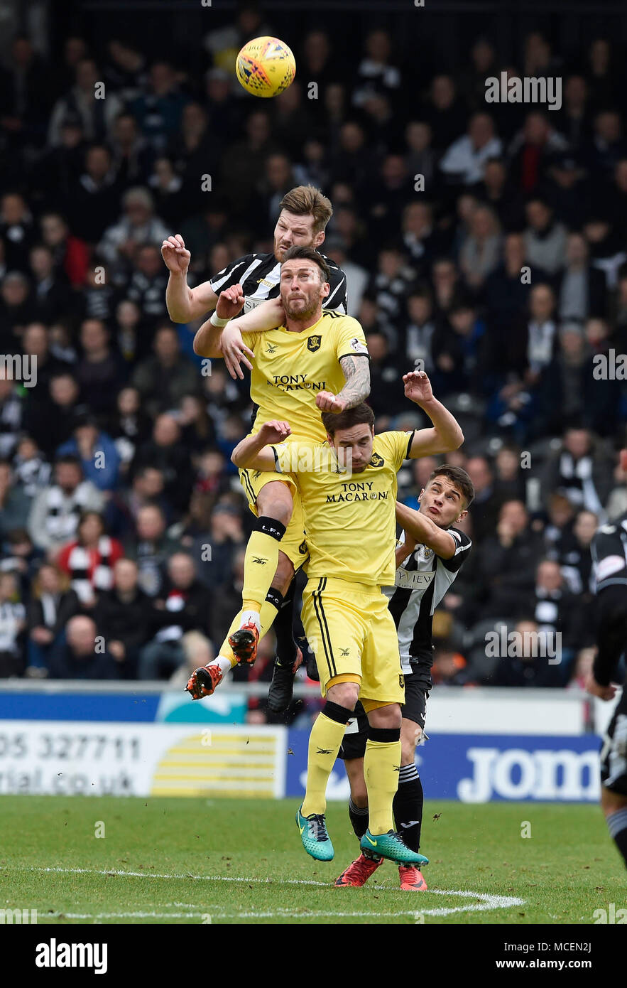St Mirren's Gary MacKenzie heads clear from and Livingston's Lee Miller ...