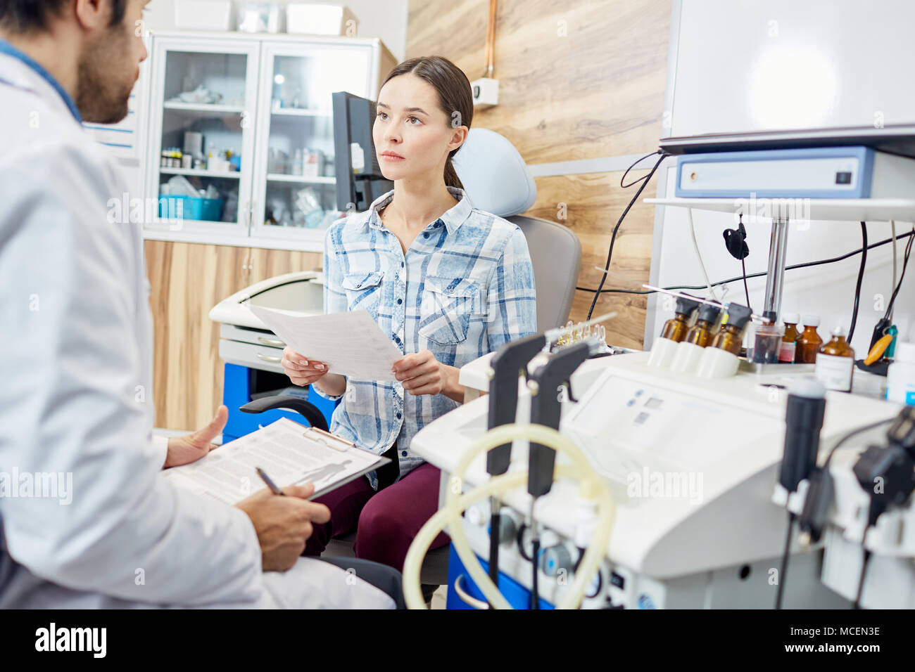 Male doctor giving recommendation to his patient at doctor's office ...