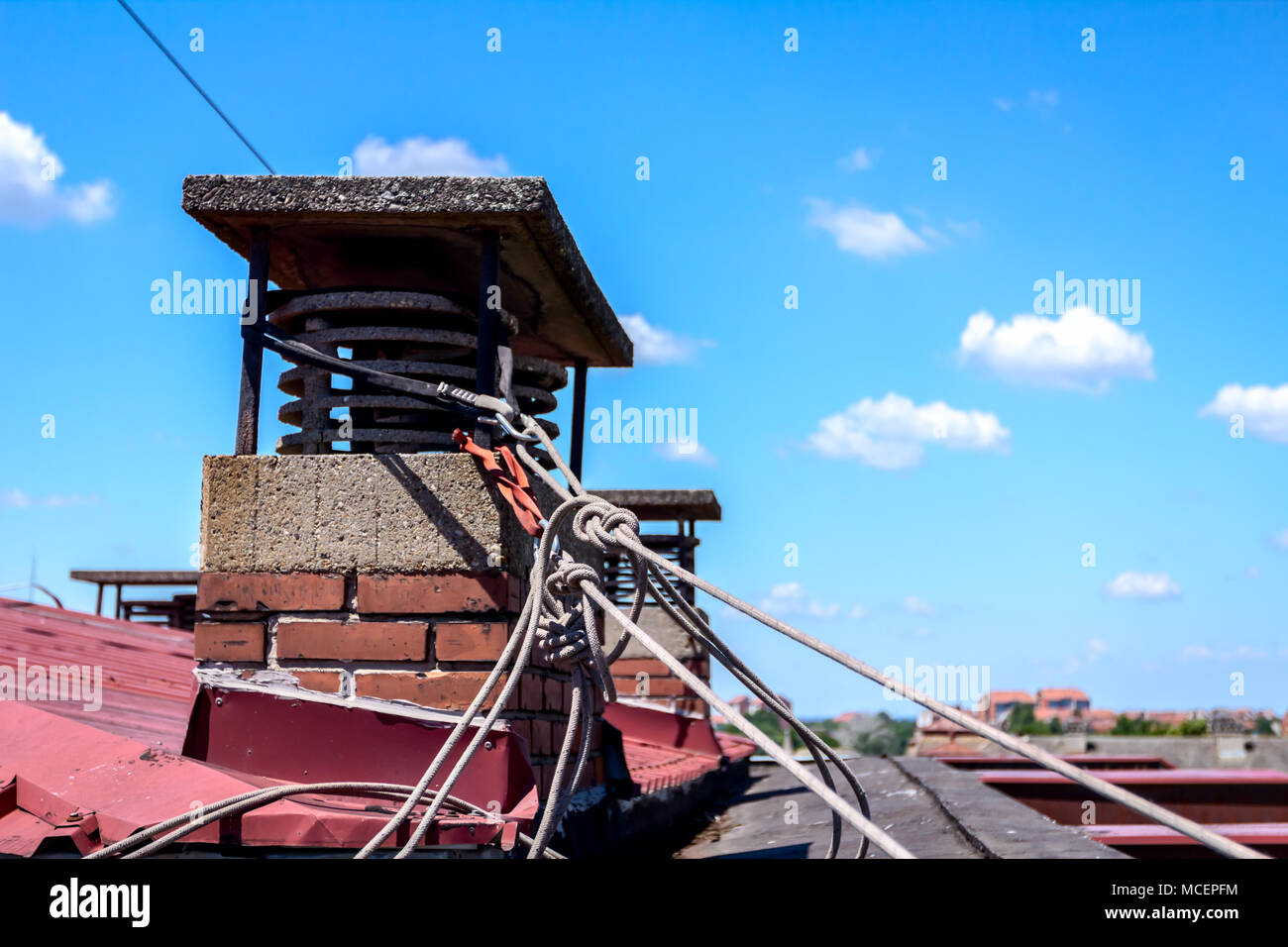 Tied ropes of industrial climbers around chimney made of bricks Stock ...