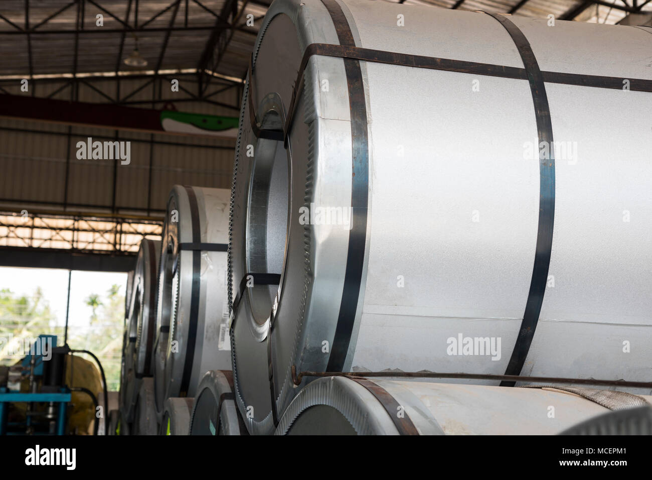 Steel Coils stock in warehouse for tile manufacturing Stock Photo - Alamy