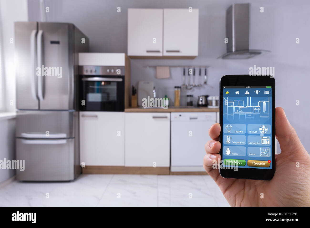 Close-up Of A Person's Hand Using Smart Home System On Mobilephone In ...