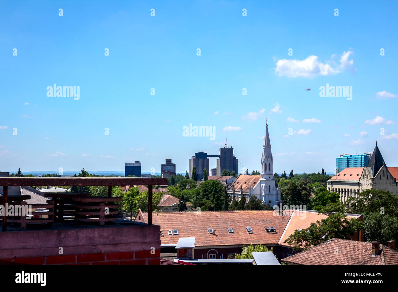 Urban landscape, city buildings with ceramic roofs and industrial ...
