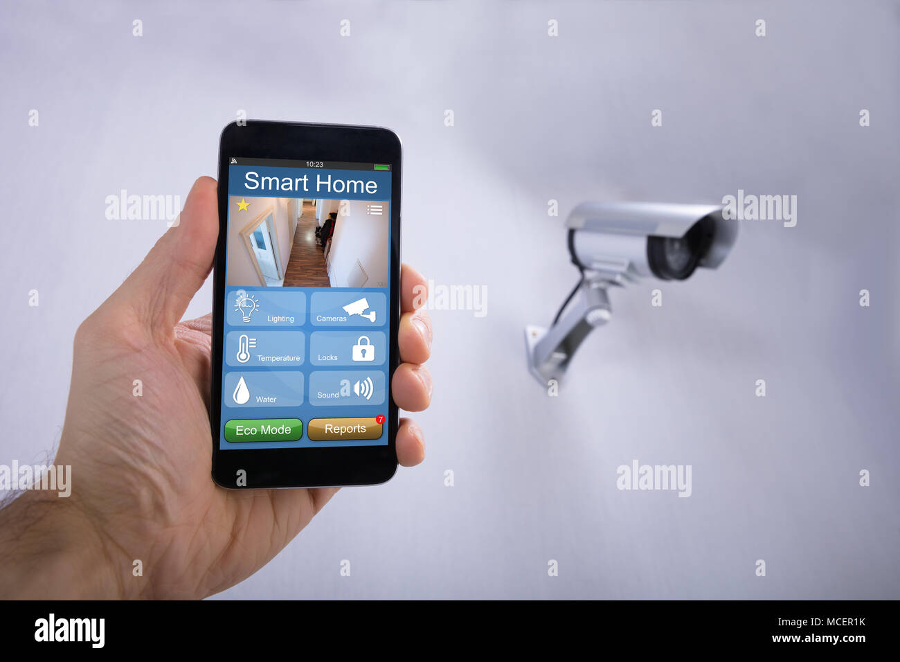 Human Hand Using Smart Home Application On Smartphone Near CCTV Camera ...