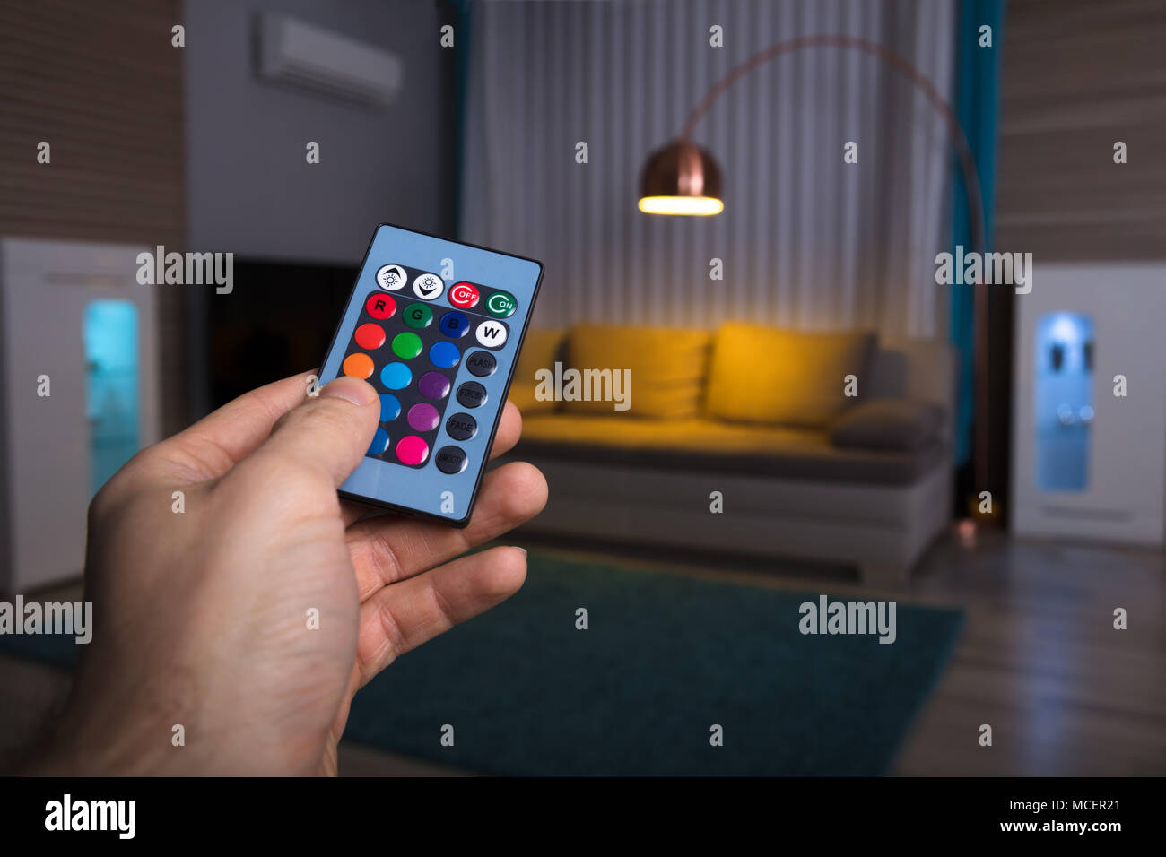 Close-up Of A Human Hand Adjusting Electric Light With Remote Control ...