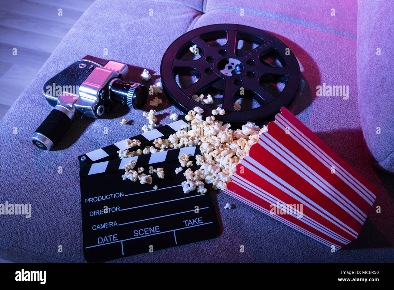 High Angle View Of Spilled Popcorn With Clapperboard And Movie Camera ...