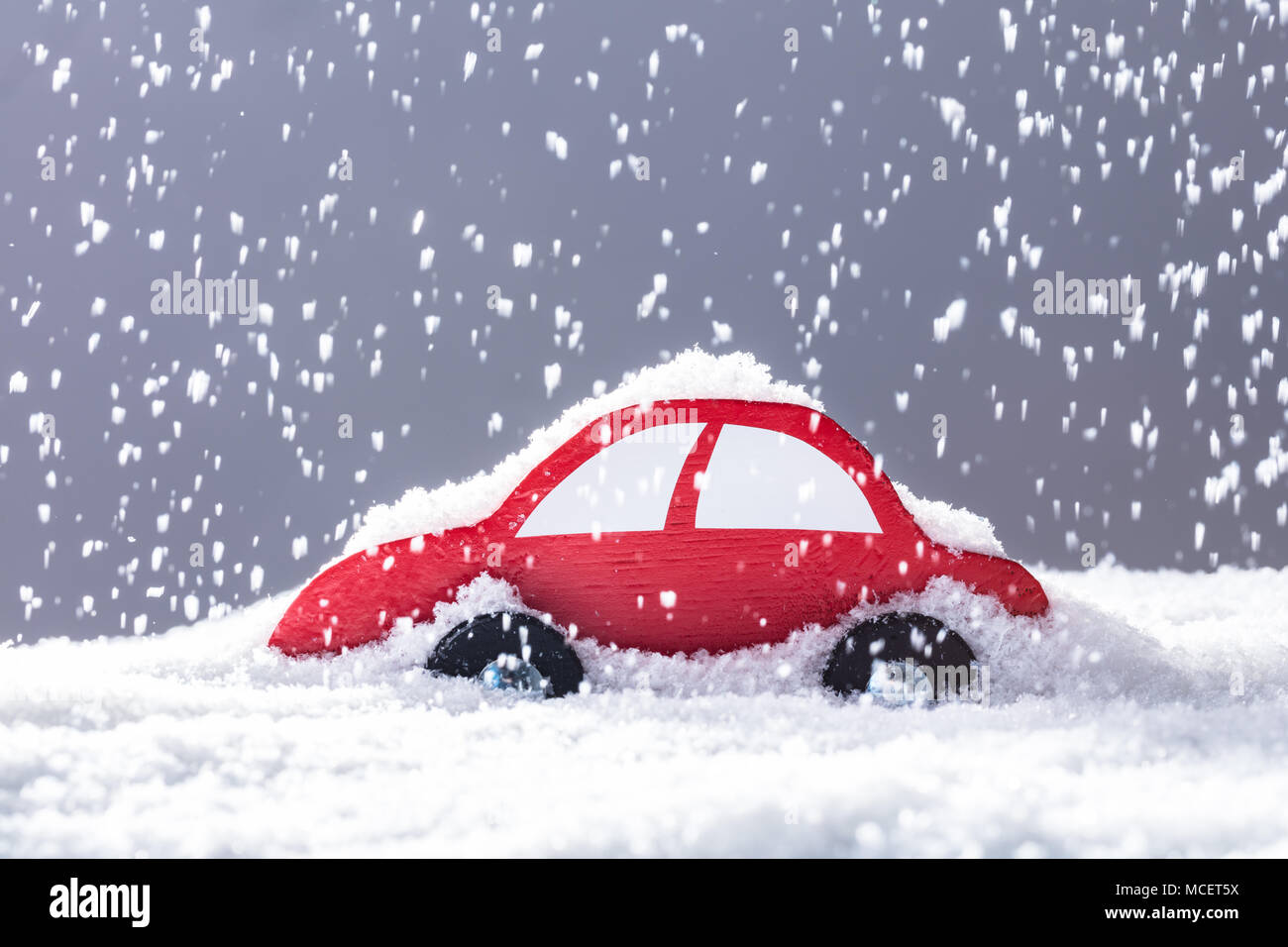Red Car Covered With Snow In Heavy Snowfall Stock Photo - Alamy