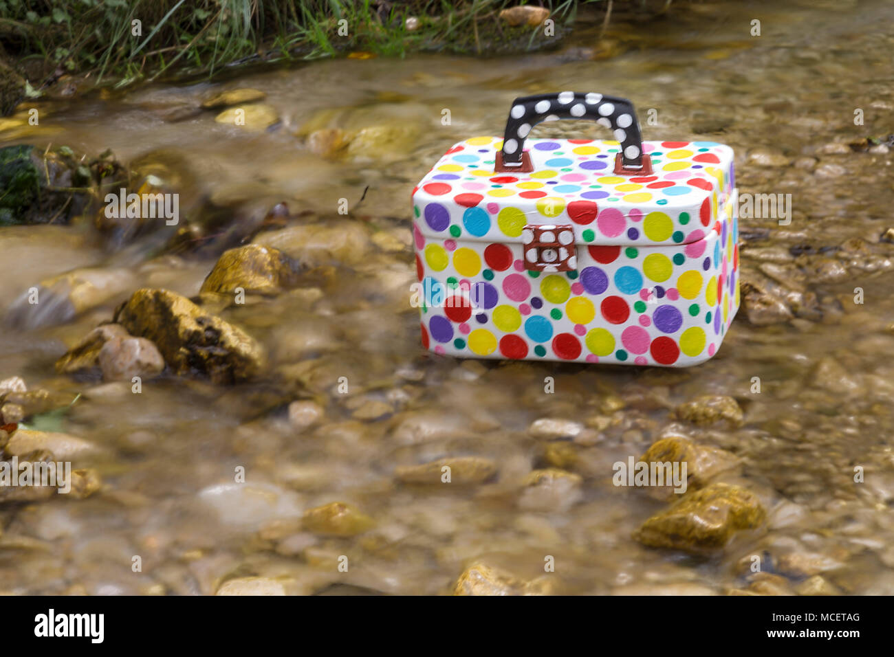 Colorful dotted box on blurred water Stock Photo - Alamy