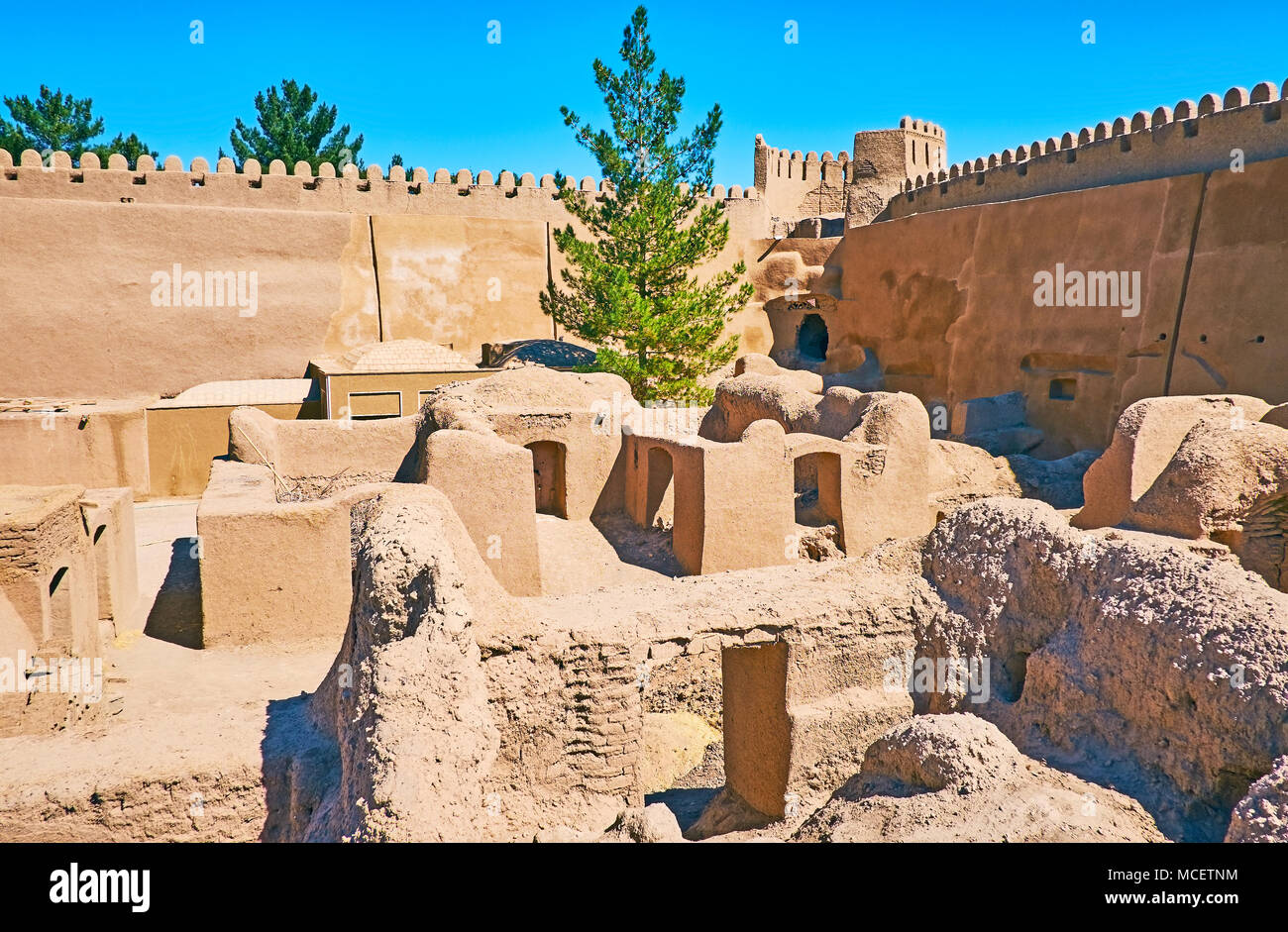 The small living buildings of ancient Rayen citadel are surrounded by ...