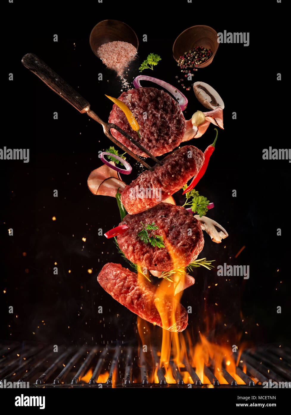 Flying pieces of beef meat pieces on hamburger from grill grid ...