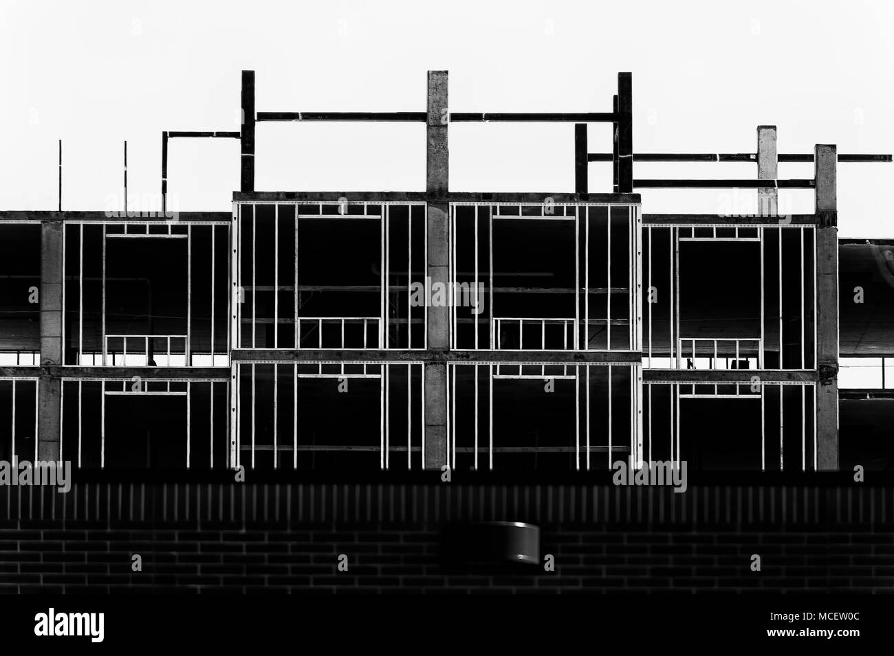 Black and white image of a building construction site. It's steel ...