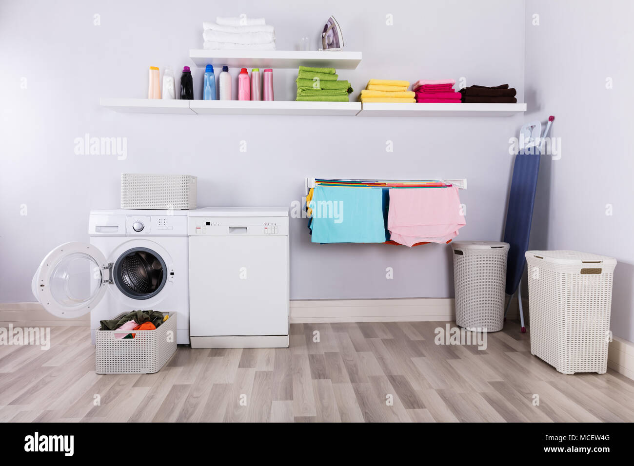 Basket Full Of Dirty Clothes In Front Of Washing Machine At Laundry ...