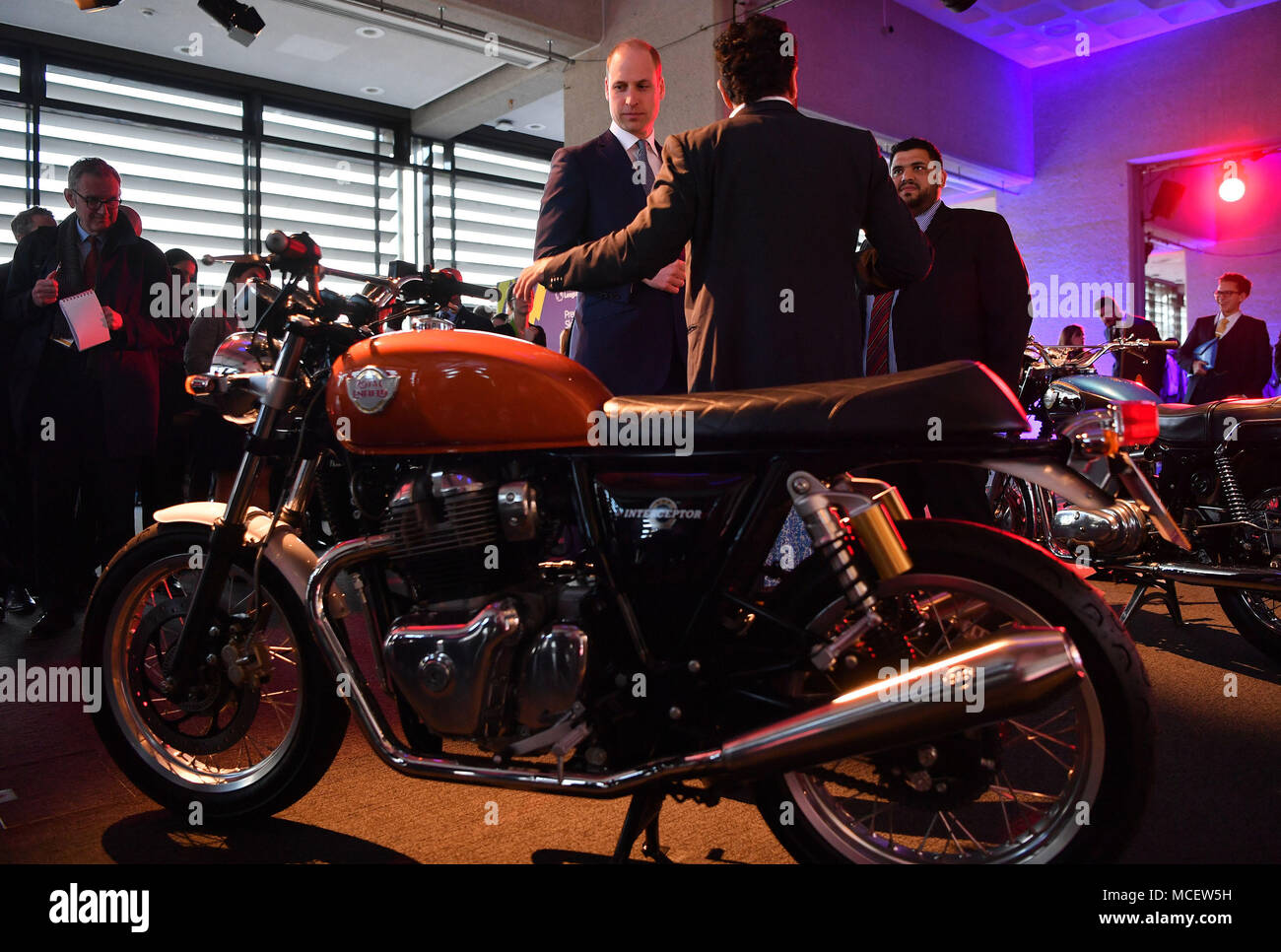 The Duke of Cambridge looks at a display of Royal Enfield motorcycles ...
