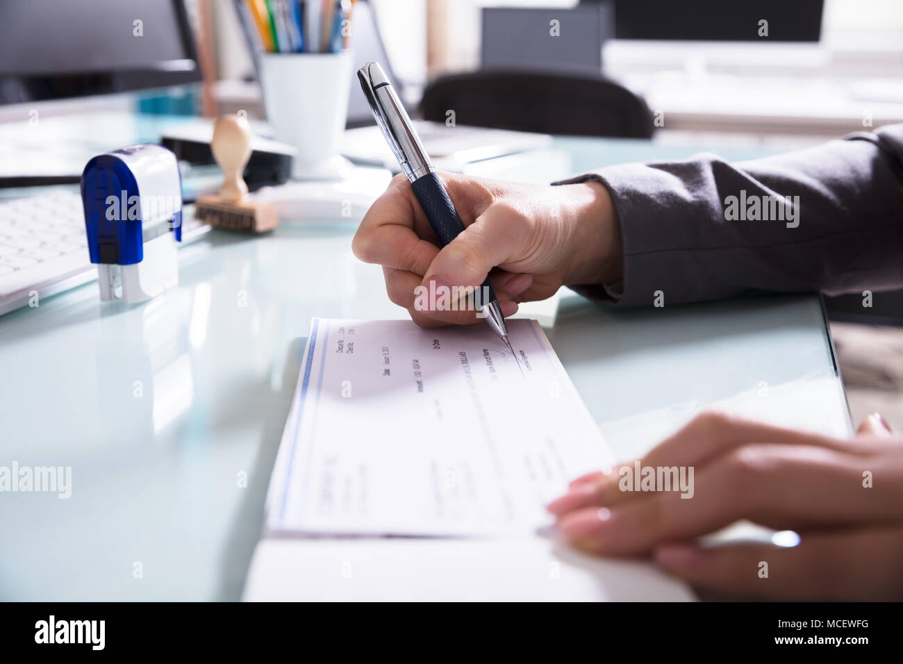 Female hand writing cheque hi-res stock photography and images - Alamy