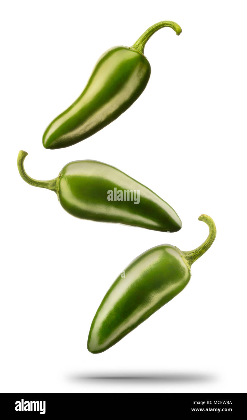 Falling green chilli pepper isolated on white Stock Photo - Alamy