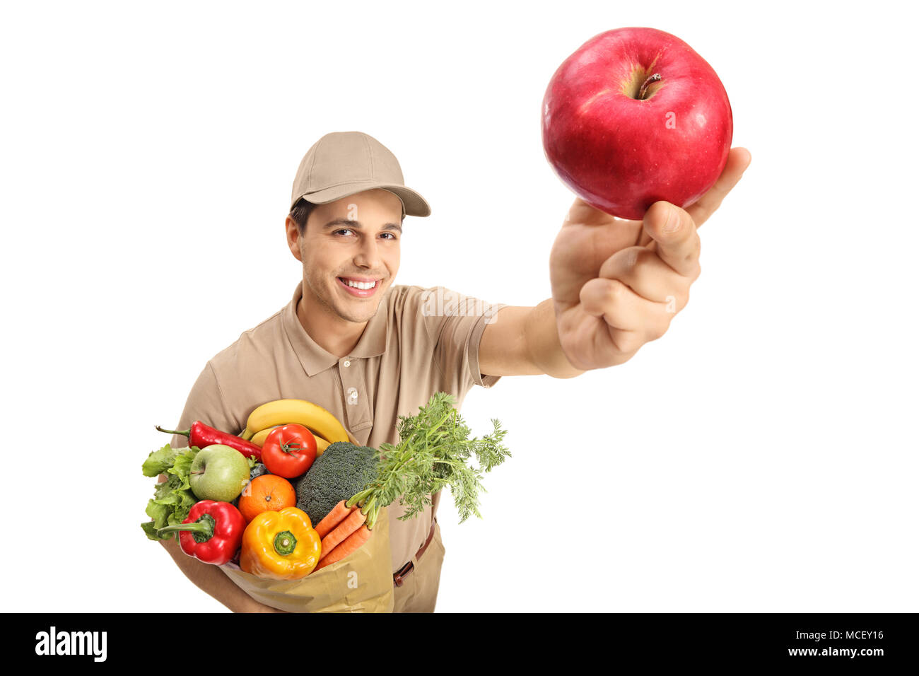 Delivery man with a bag of groceries and an apple isolated on white ...