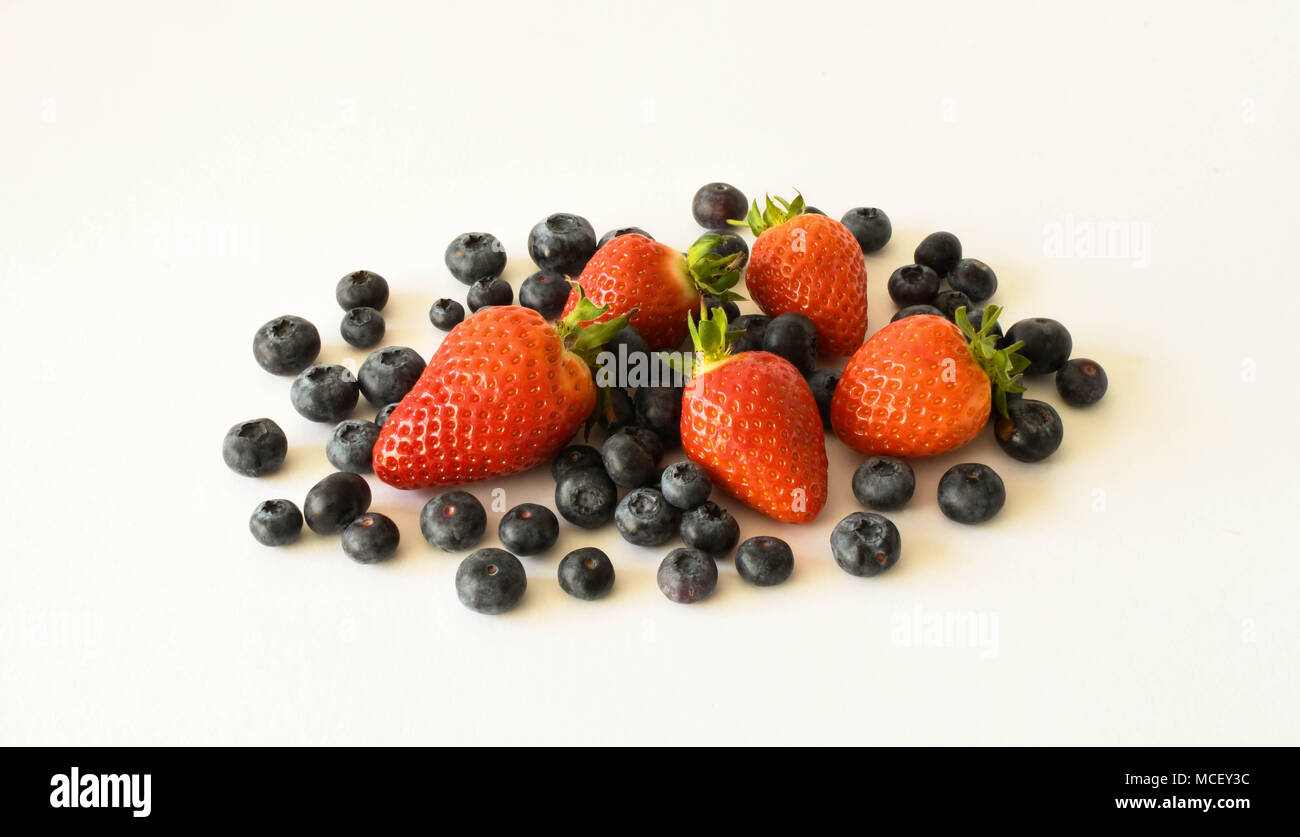 Strawberries and blueberries on a plain white background Stock Photo ...