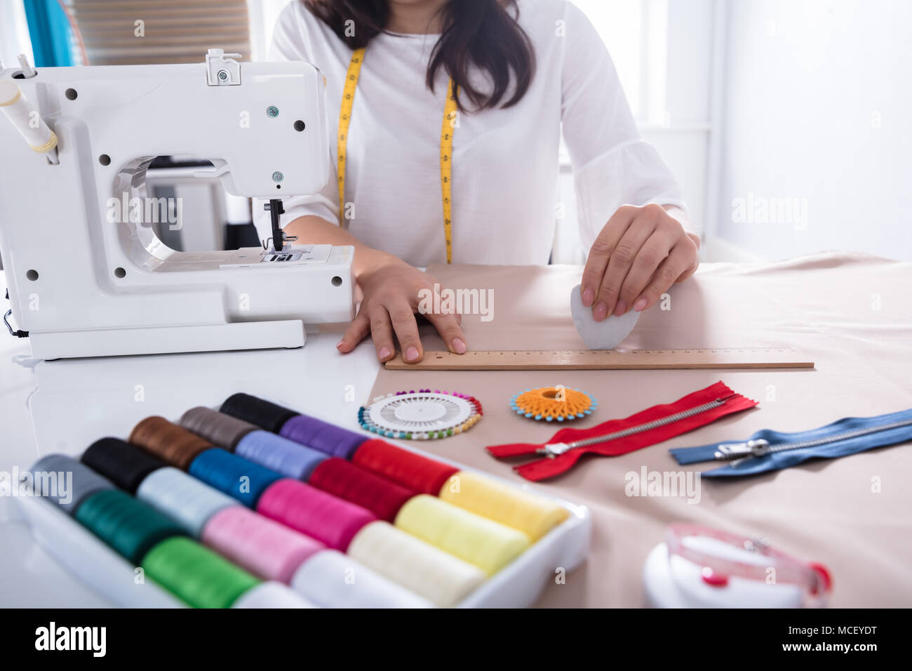 Close-up Of A Fashion Designer's Hand Measuring Fabric With Ruler In ...