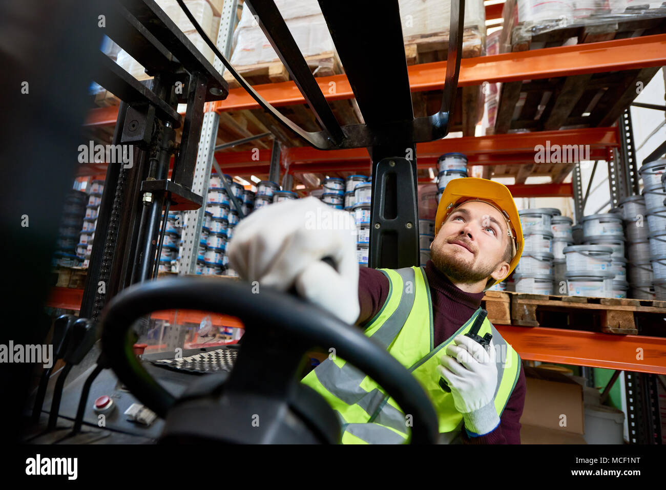Warehouse Worker Moving Goods Using Forklift Stock Photo - Alamy